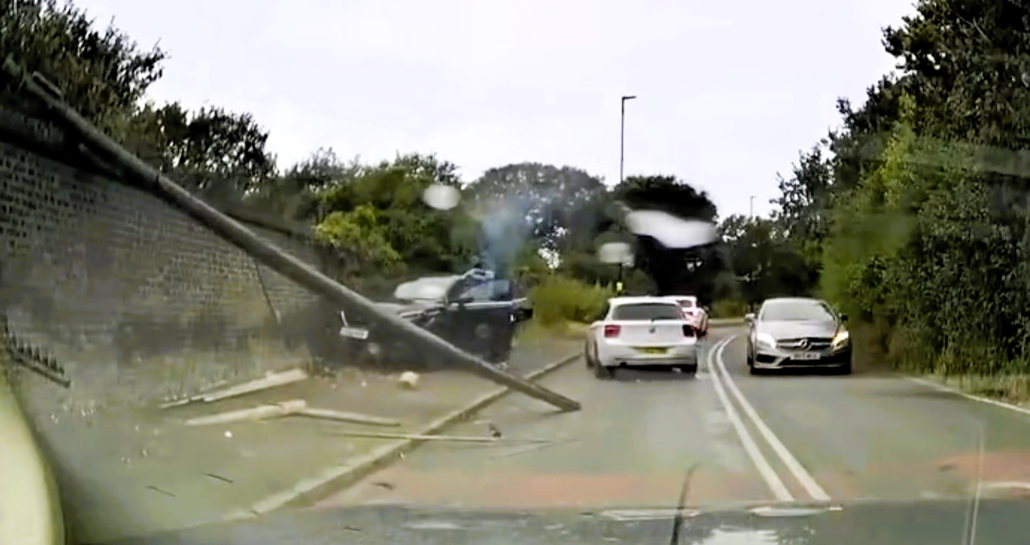 Horror moment car crashes into telegraph pole sending it flying out of ...