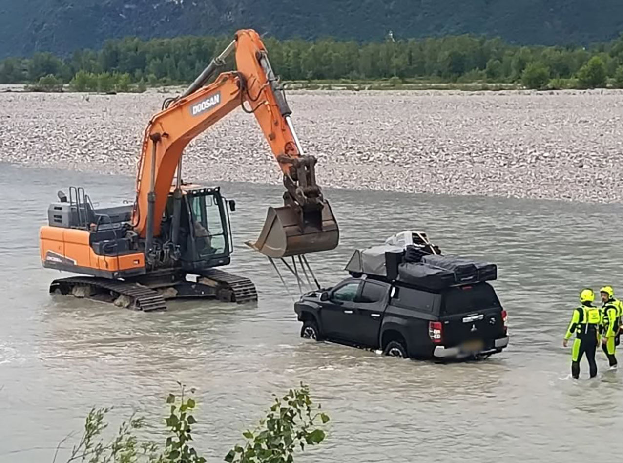 Tourists rescued with their dogs after pickup truck gets stuck in fast ...